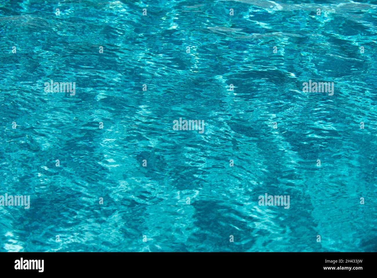 Background of blue water in swimming pool with sun reflection, ripple ...