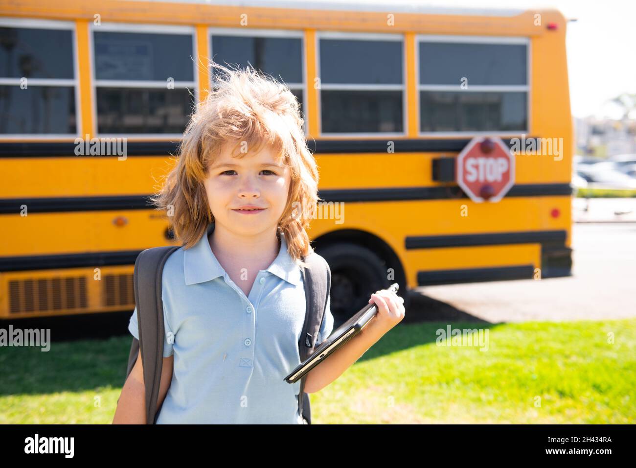 Back to school. Happy child near school bus. Cute school boy potrait ...