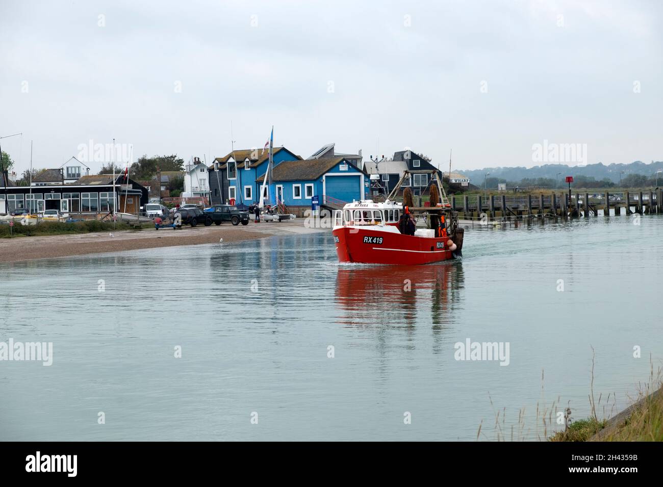 Red triple-rig trawl fishing boat My Sara in autumn October sailing to ...