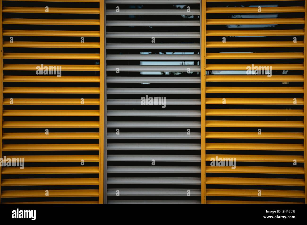 window blinds made of wood in orange and gray and a reflection in the ...