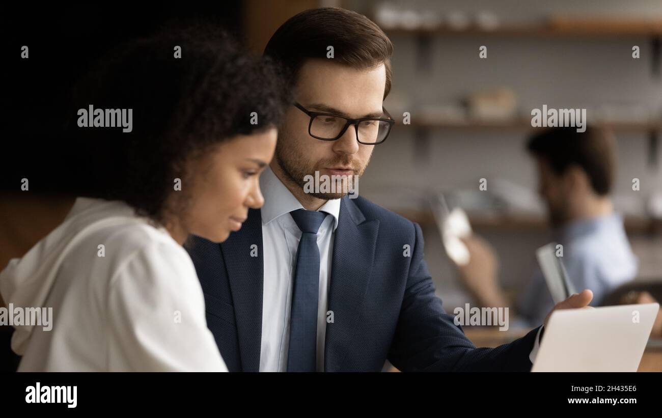 Focused diverse employees working on computer in office Stock Photo - Alamy