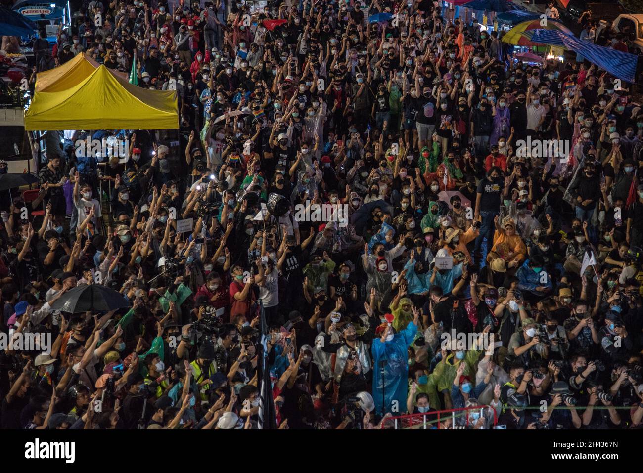 Crowd of protesters make three finger salute during the demonstration ...