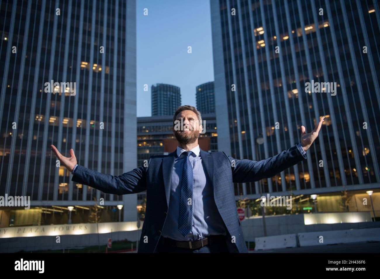 Business man stand up and night city background. Businessman raising ...