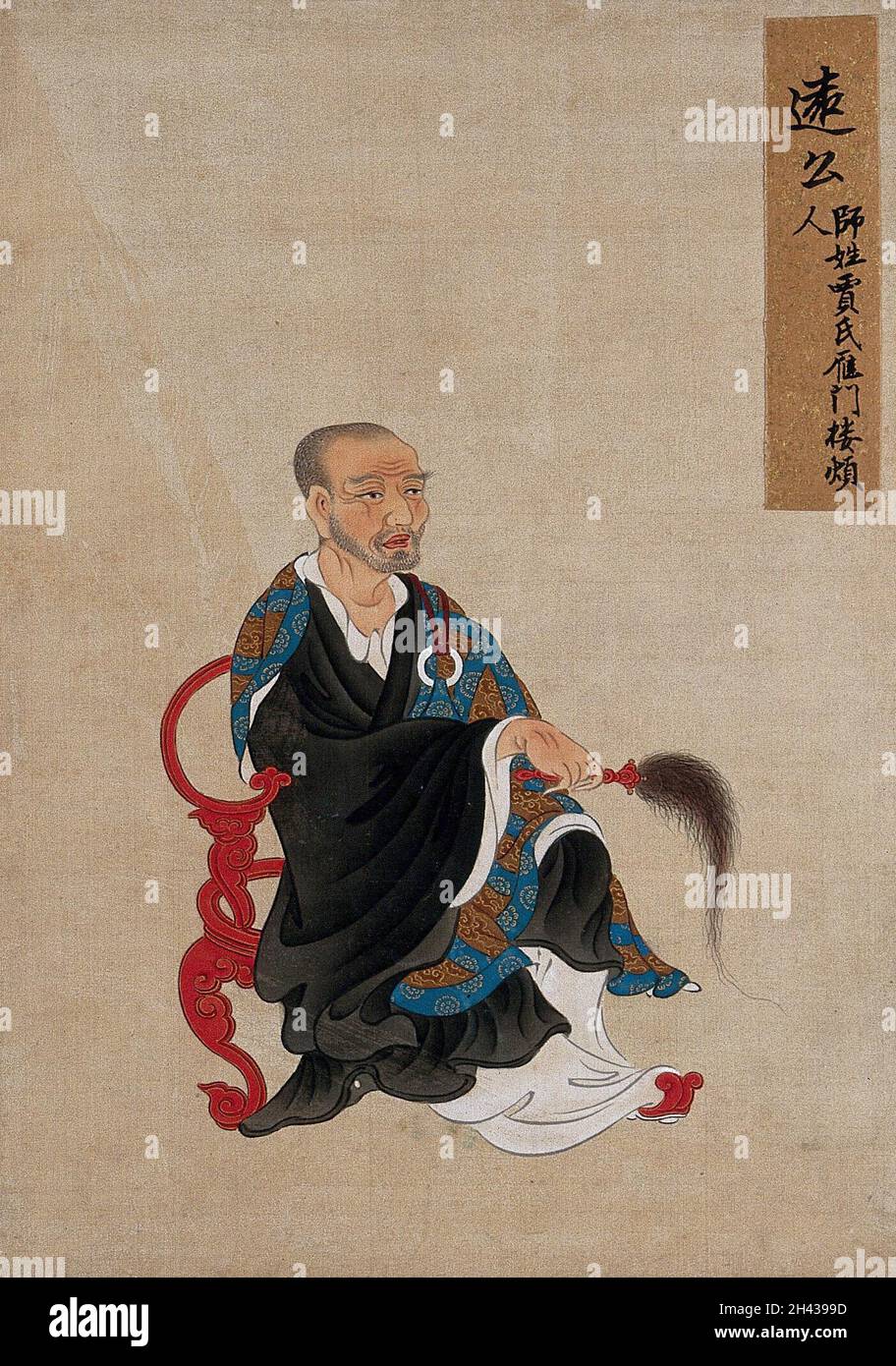 A Chinese figure, seated, wearing black robes with a black, with ...