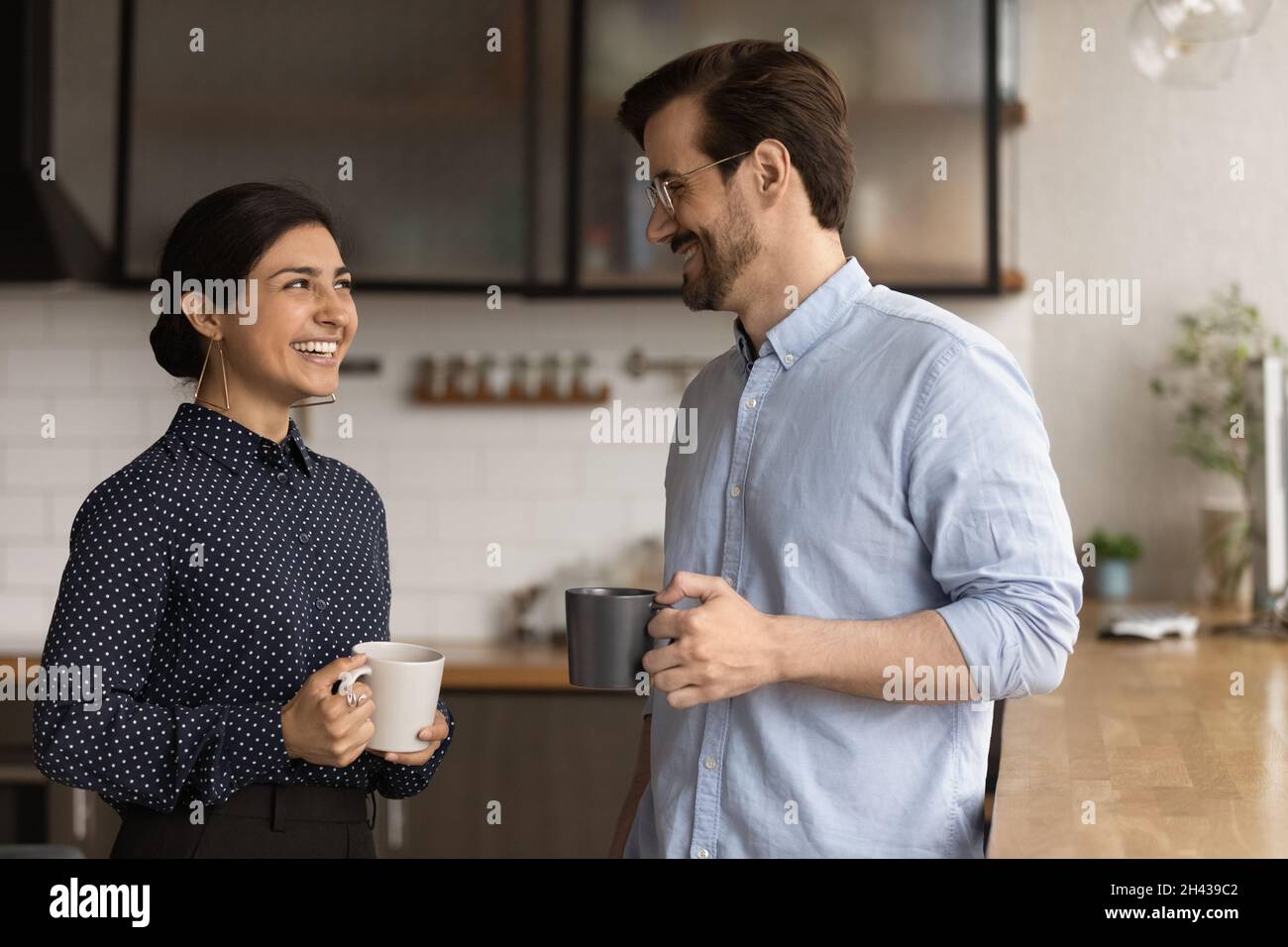 Happy female indian employee communicating with male colleague Stock ...