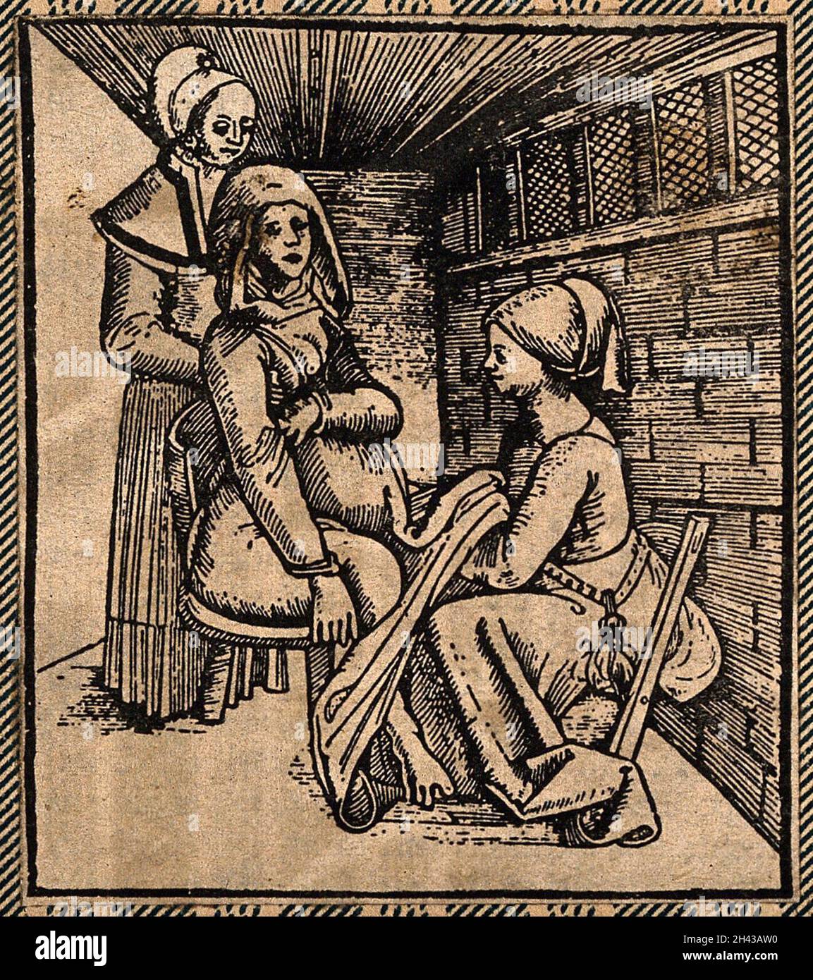 A woman seated on a obstetrical chair giving birth aided by a midwife ...