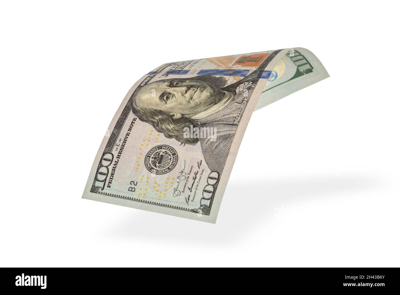 Hundred dollar bill falling casting shadow, half-folded bill close-up ...