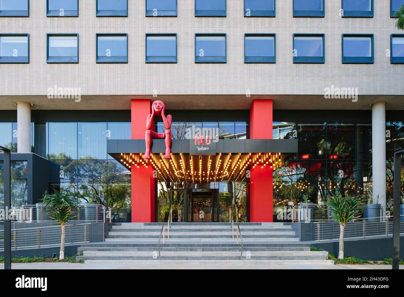 Main entrance with the grid of hotel room windows. Radisson RED ...