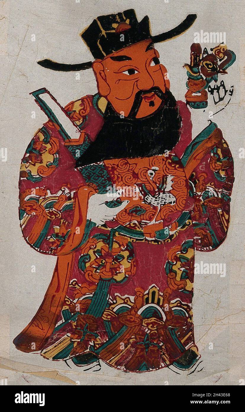 A Chinese lucky charm decoration of man dressed in brightly colored ...