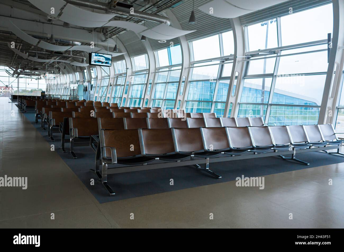 Deserted airport terminal. Rows of empty seats in the waiting room ...