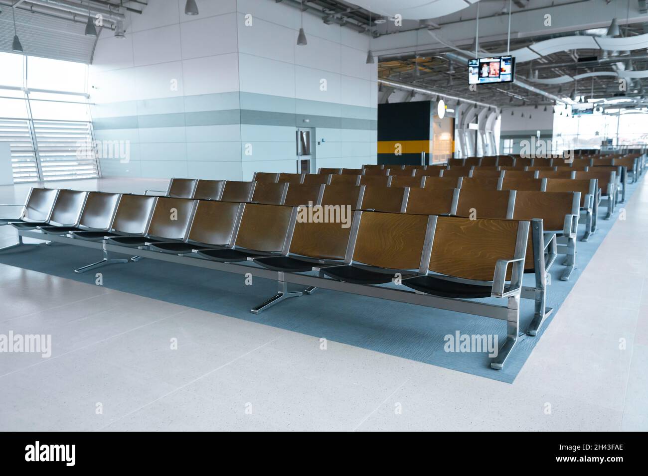 Deserted airport terminal. Rows of empty seats in the waiting room ...