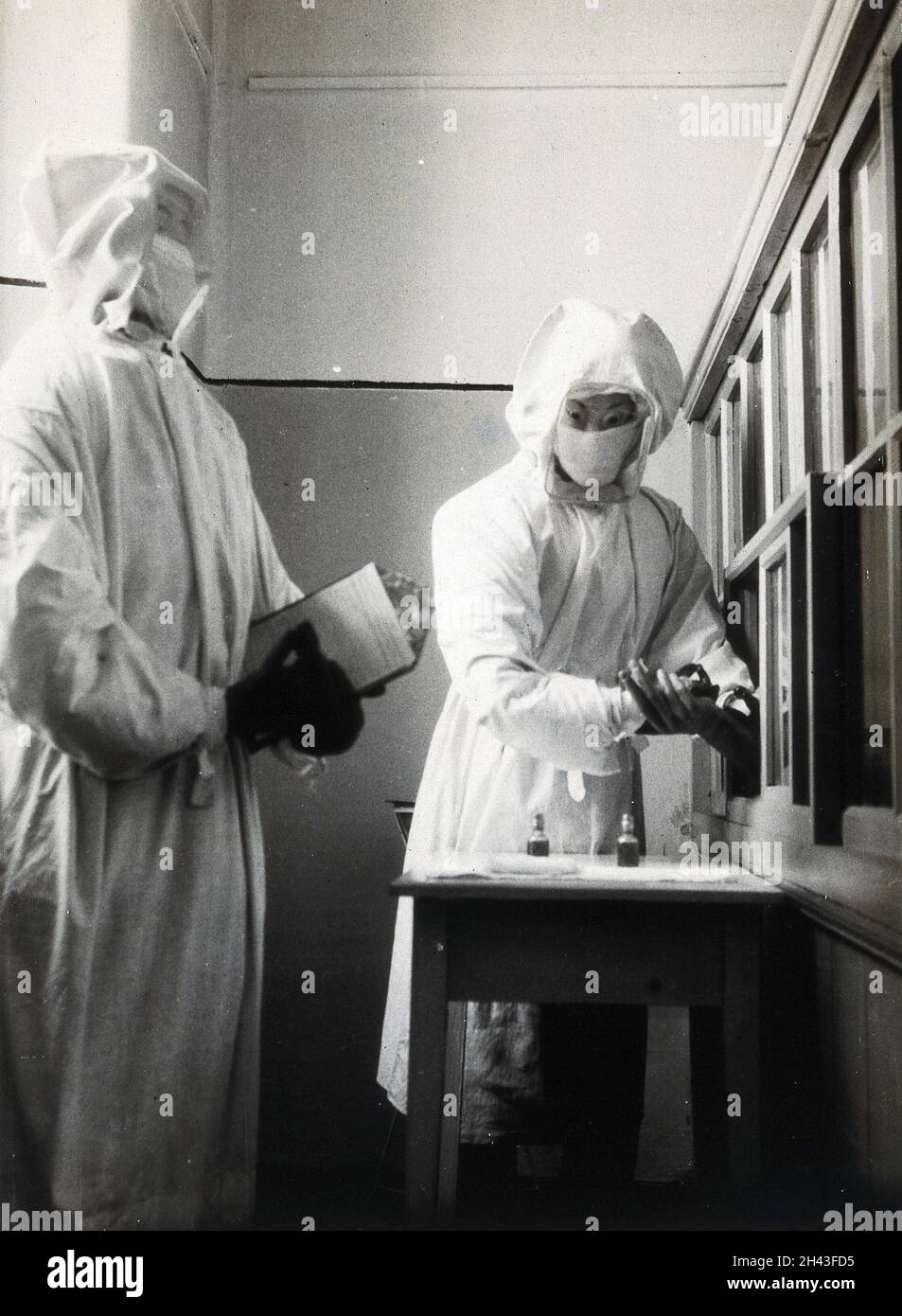 The inoculation of an isolated plague patient in China. Photograph ...