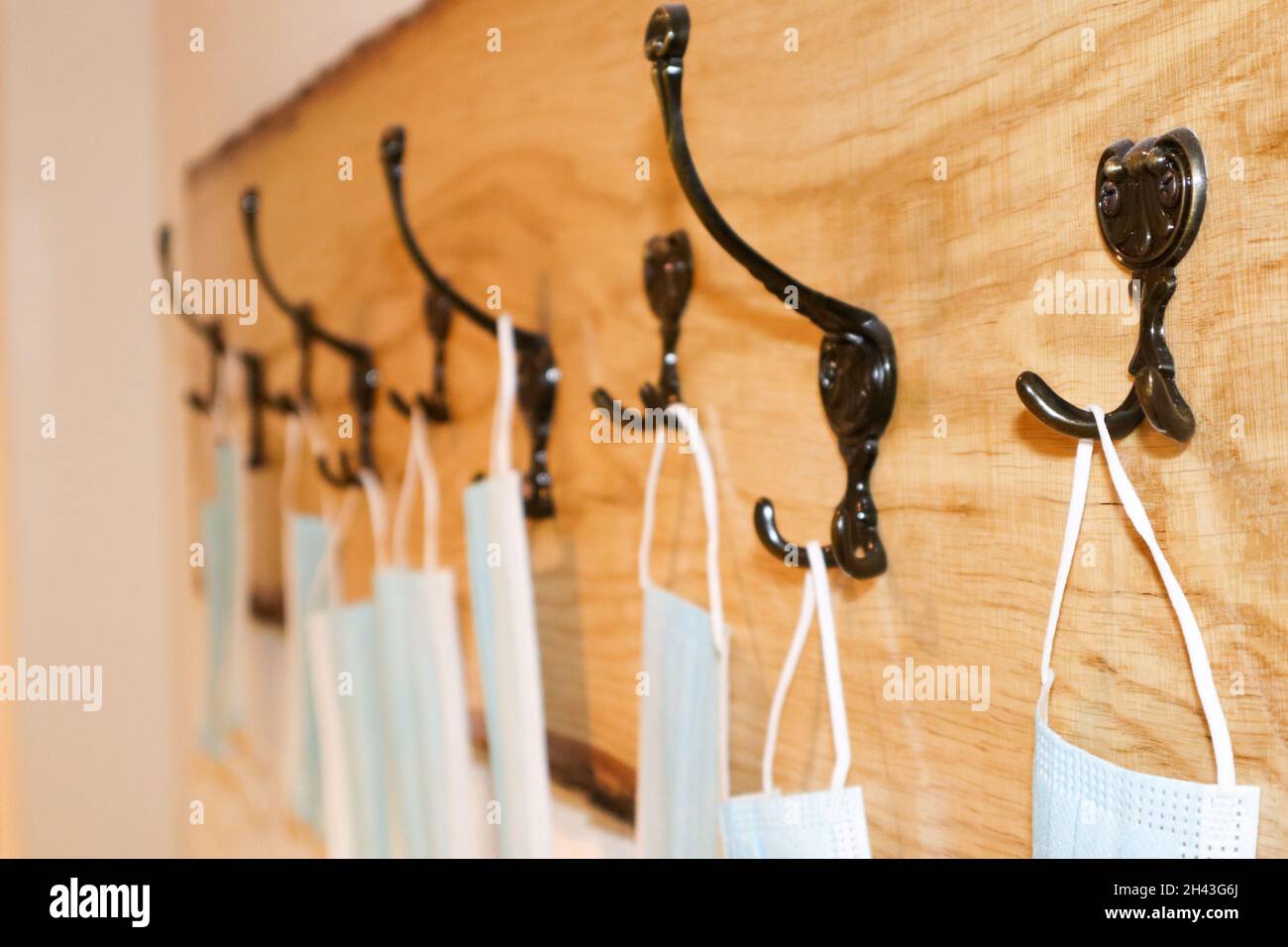 corona masks hanging on hooks Stock Photo - Alamy