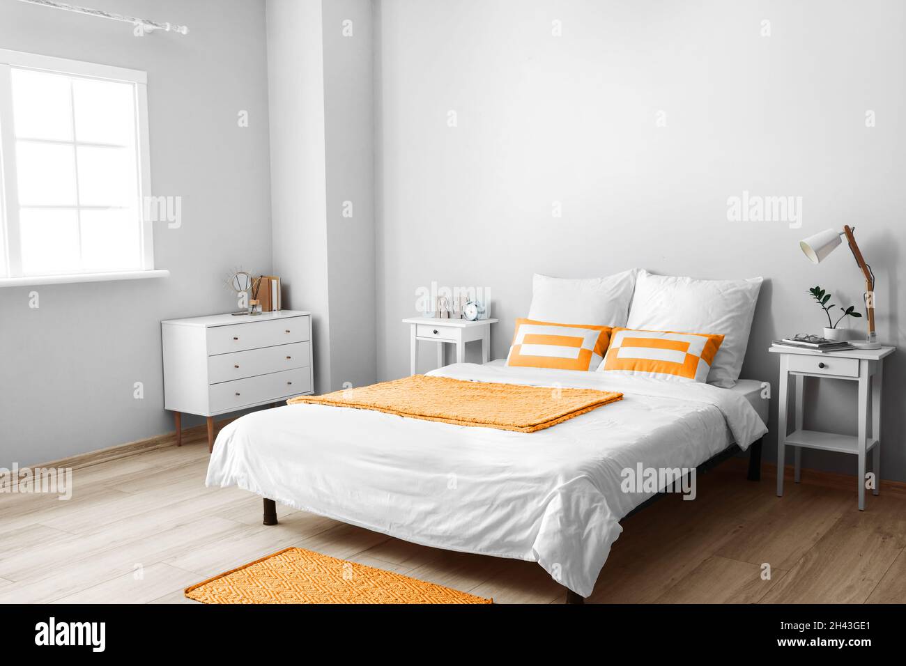 Interior of stylish light room with comfortable bed Stock Photo - Alamy