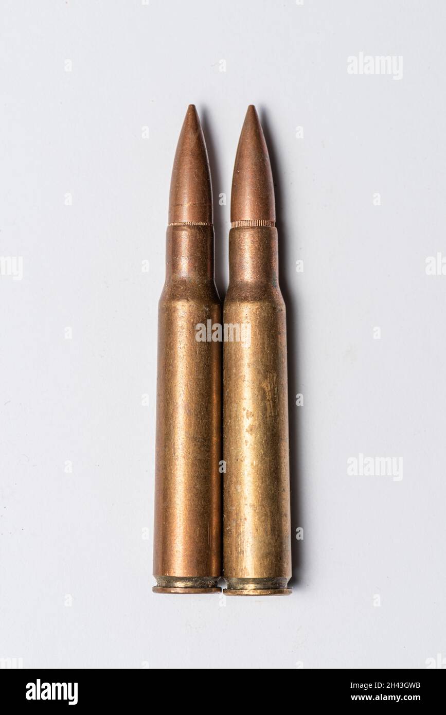 Two rifle bullets on white background Stock Photo - Alamy