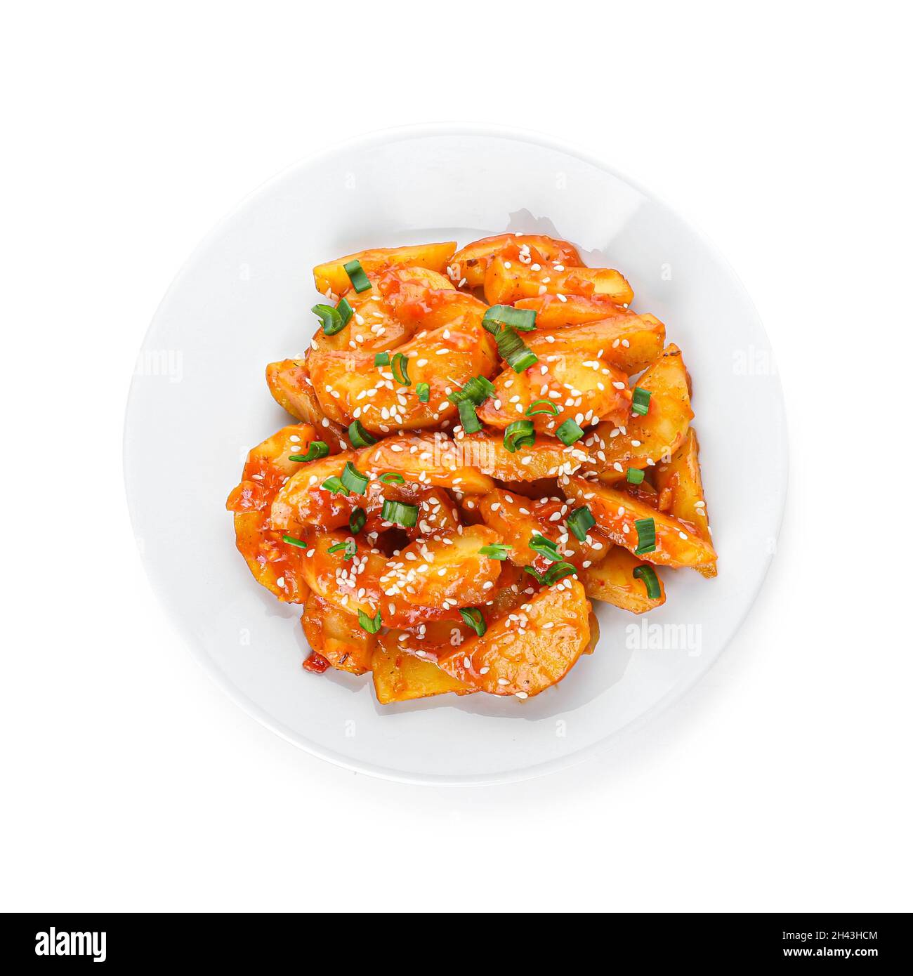 Plate with honey chilli potato on white background Stock Photo - Alamy