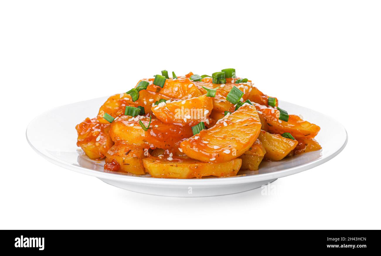 Plate with honey chilli potato on white background Stock Photo - Alamy