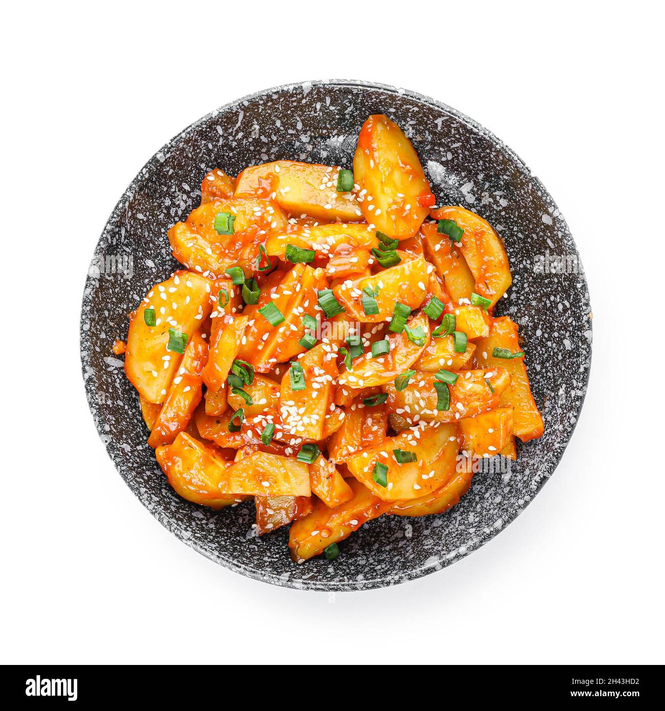 Plate with honey chilli potato on white background Stock Photo - Alamy