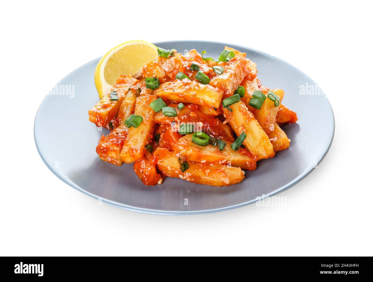 Plate with honey chilli potato on white background Stock Photo - Alamy