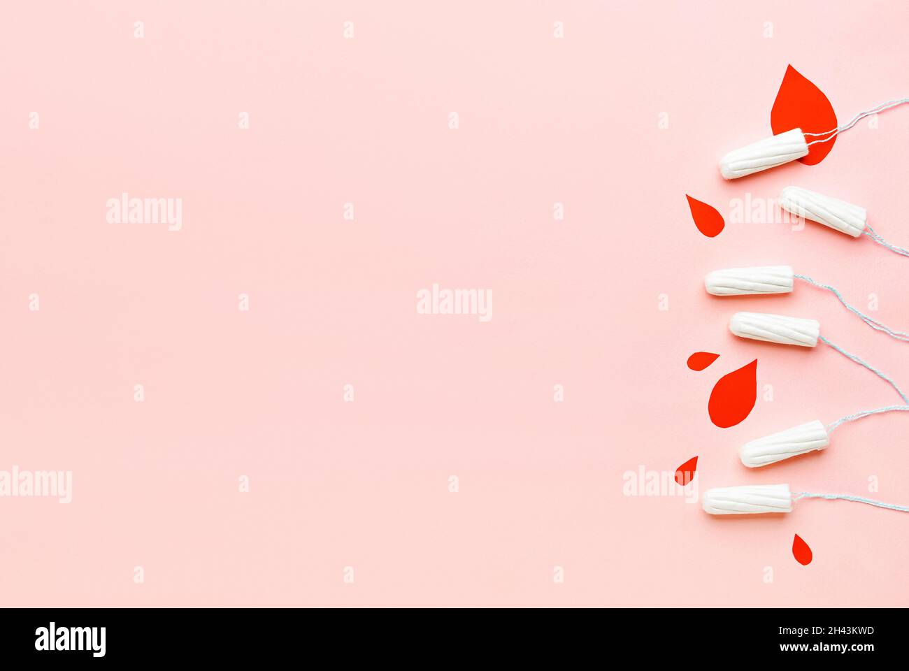 Menstrual tampons and paper blood drops on pink background Stock Photo ...