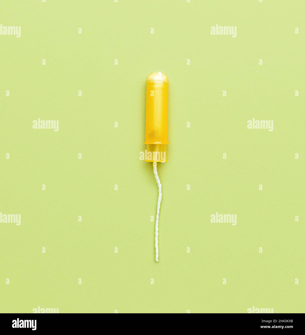 Menstrual tampon on green background Stock Photo - Alamy