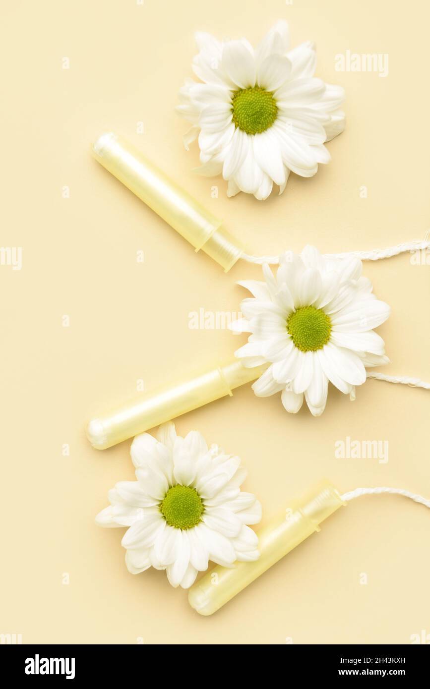Menstrual tampons and flowers on color background Stock Photo - Alamy