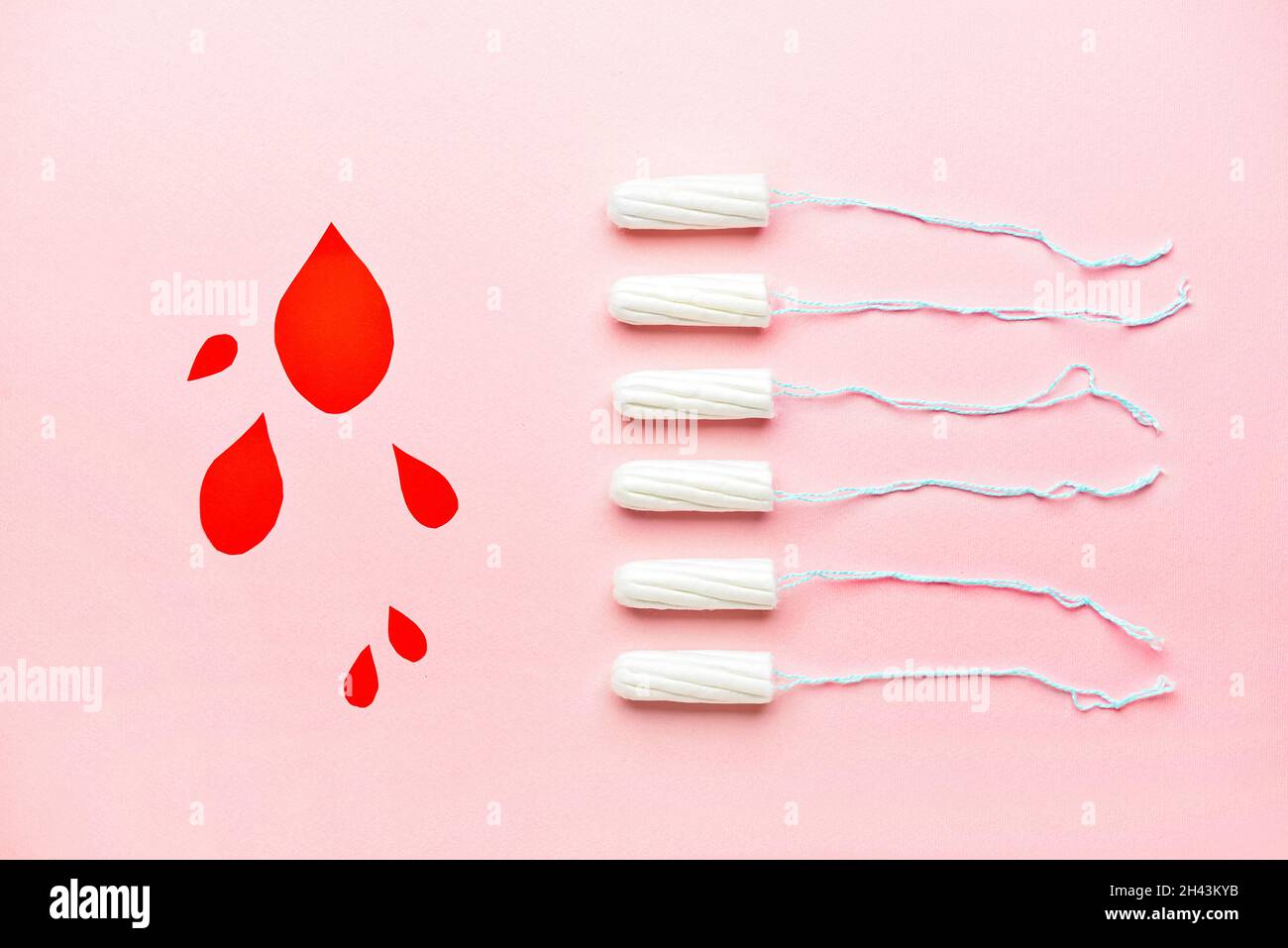 Menstrual tampons and paper blood drops on pink background Stock Photo ...