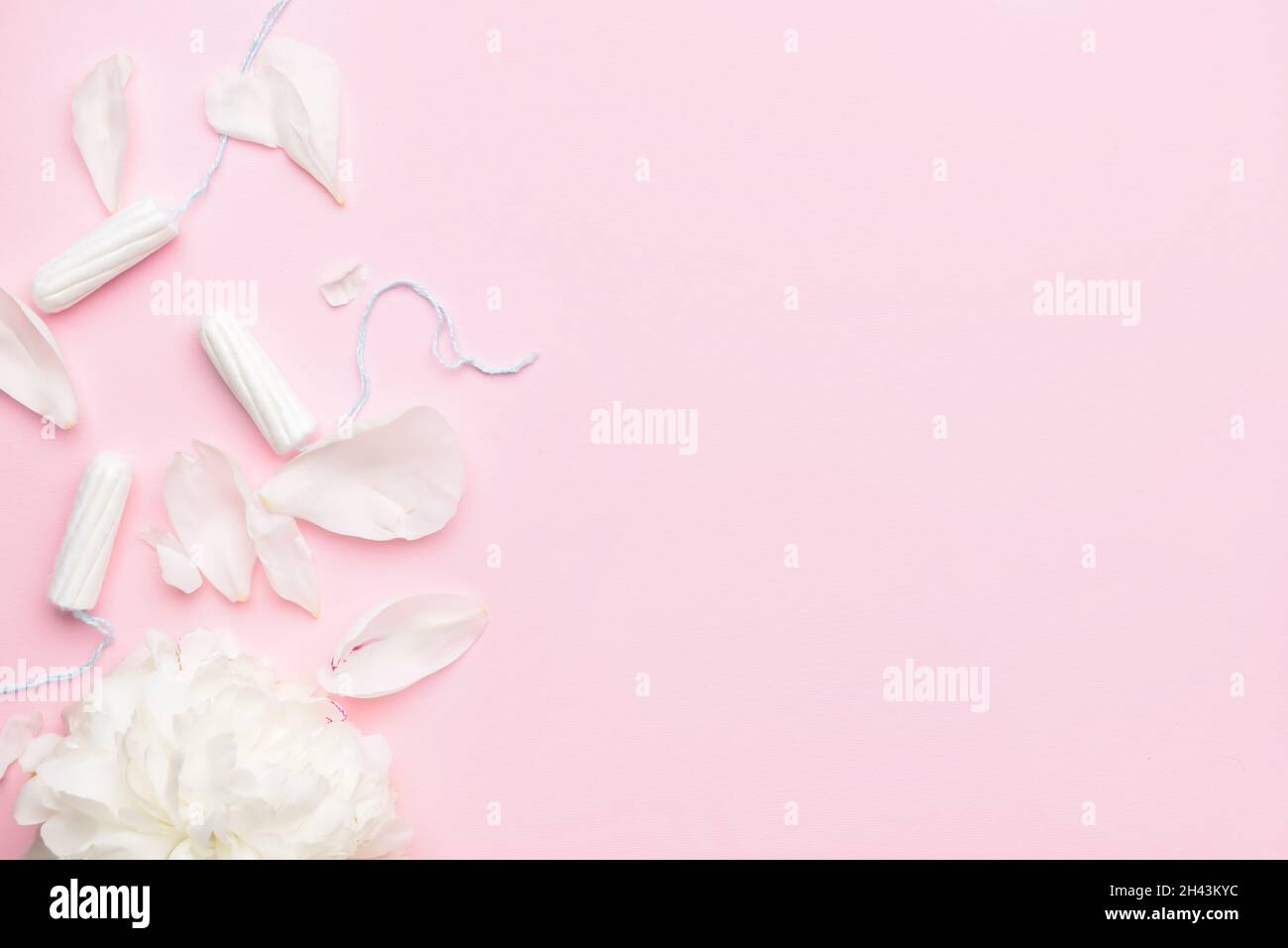 Menstrual tampons and flower on pink background Stock Photo - Alamy