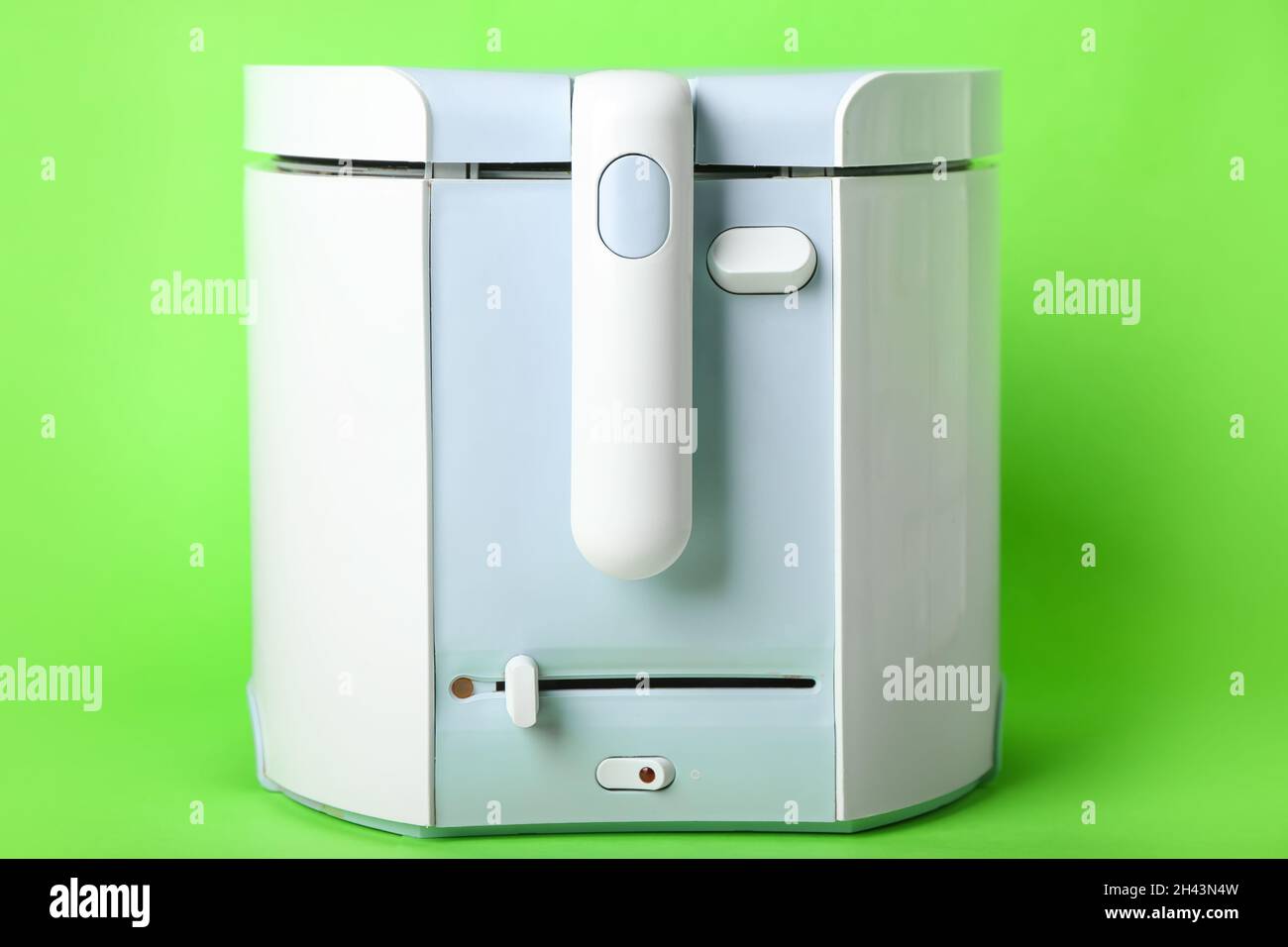 Modern deep fryer on color background Stock Photo - Alamy