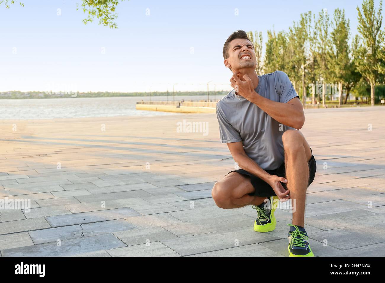Young man scratching himself outdoors Stock Photo - Alamy