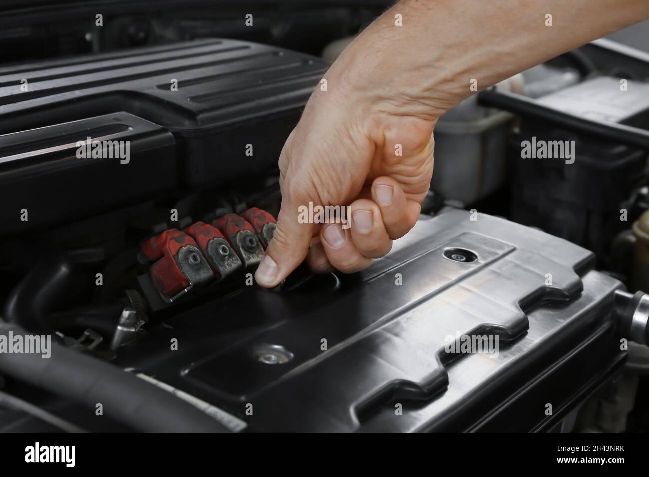 Male mechanic opening car engine Stock Photo - Alamy