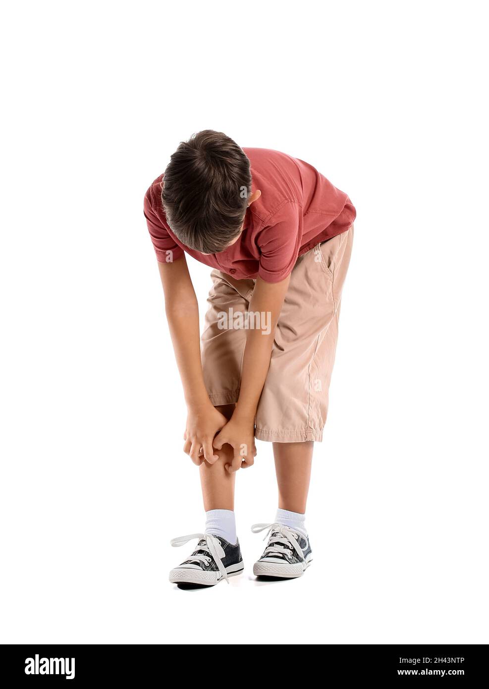 Little boy scratching himself on white background Stock Photo - Alamy