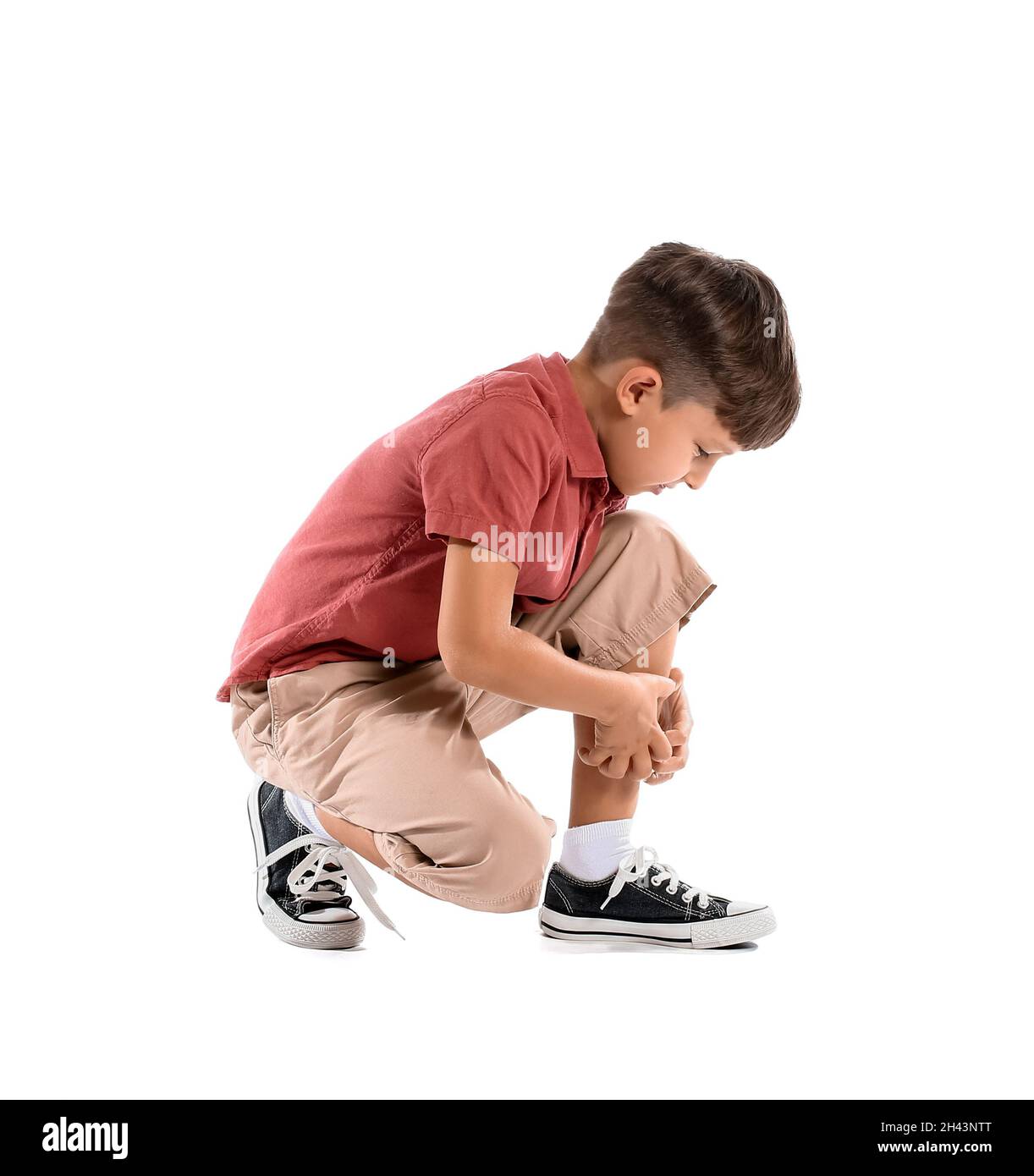 Little boy scratching himself on white background Stock Photo - Alamy