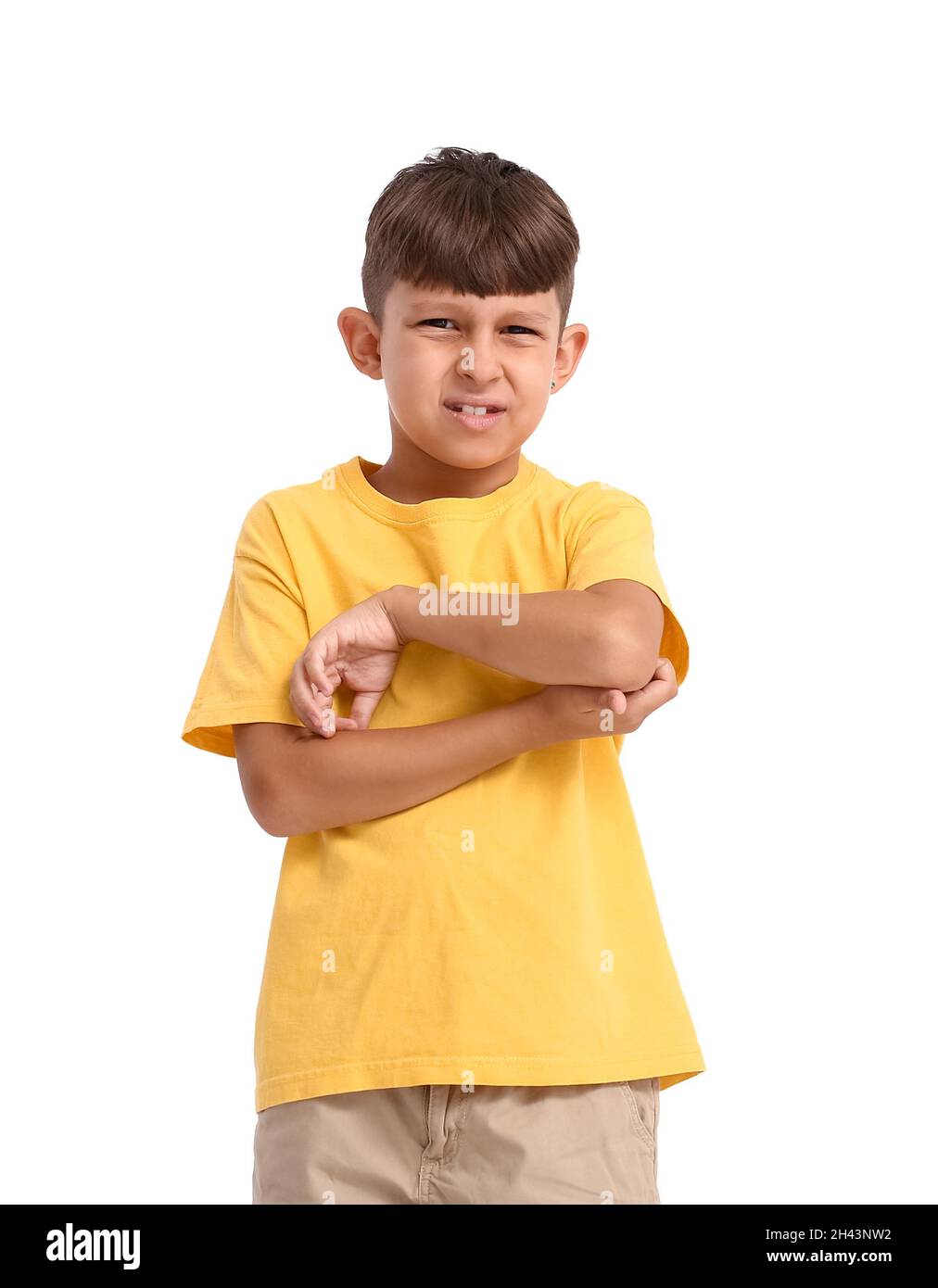 Little boy scratching himself on white background Stock Photo - Alamy
