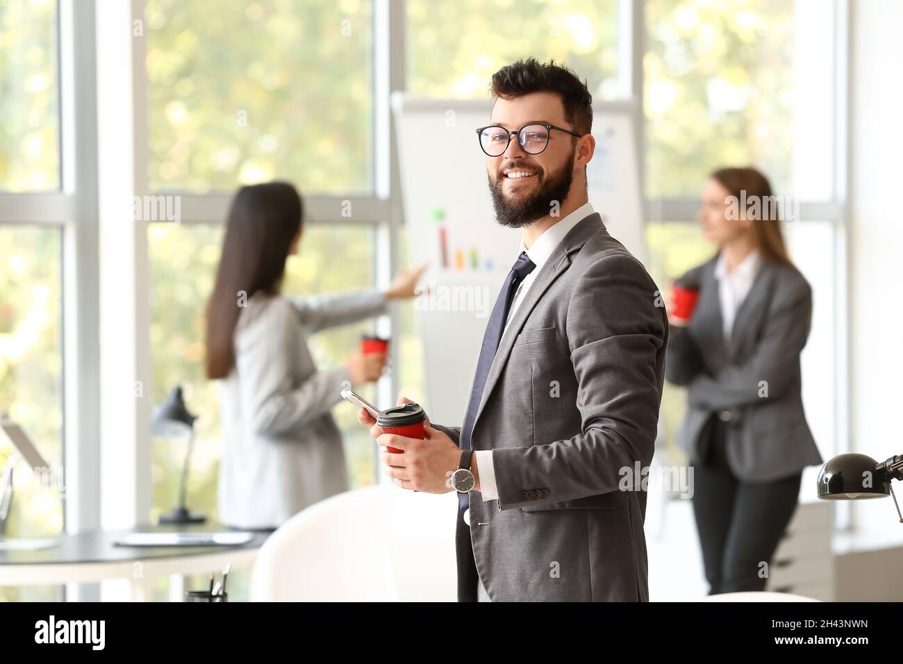 Man having coffee break in office Stock Photo - Alamy