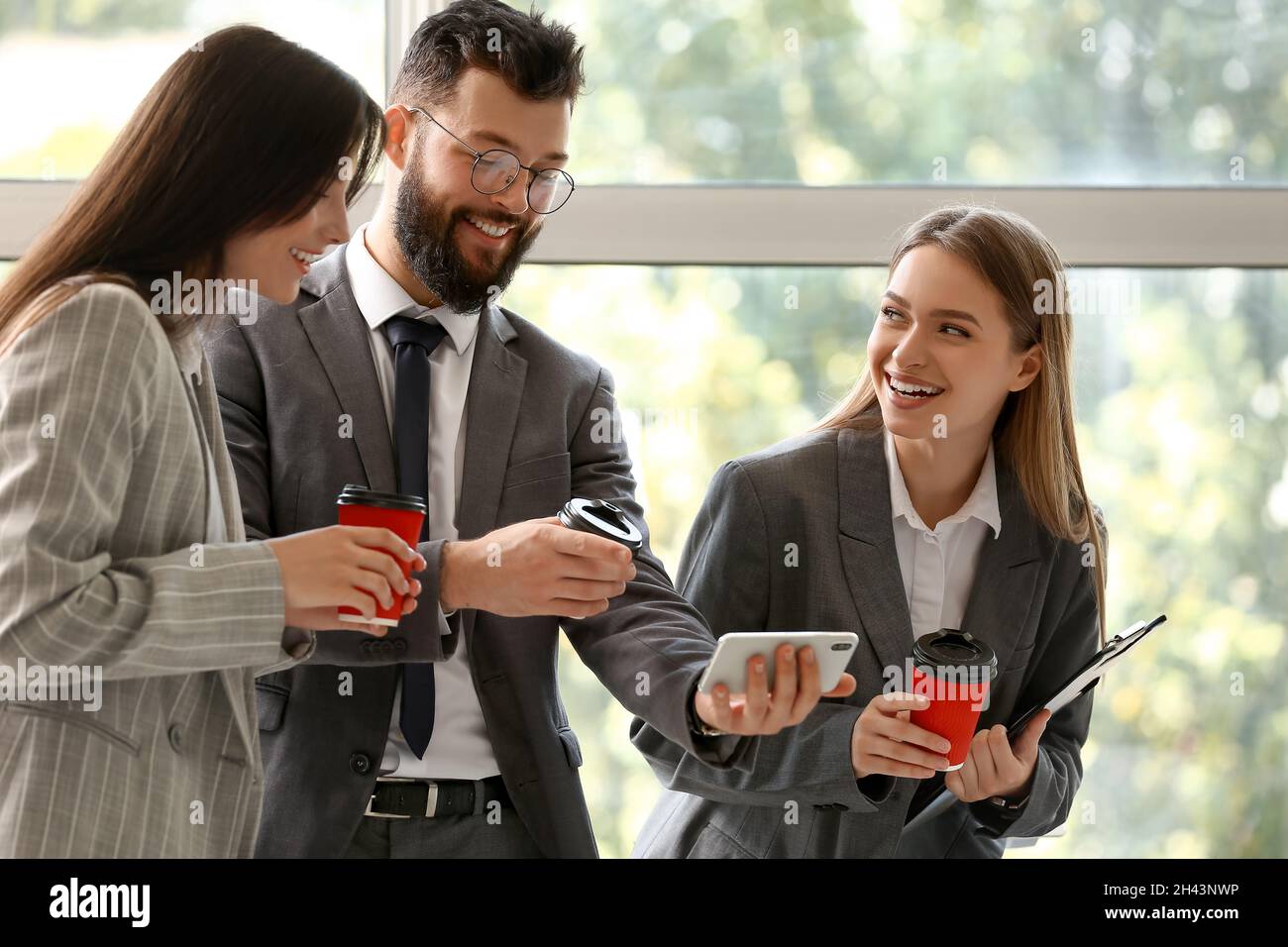 Business people having coffee break in office Stock Photo - Alamy
