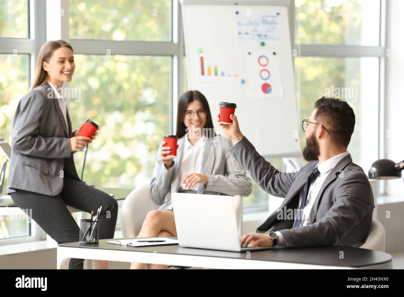 Business people having coffee break in office Stock Photo - Alamy