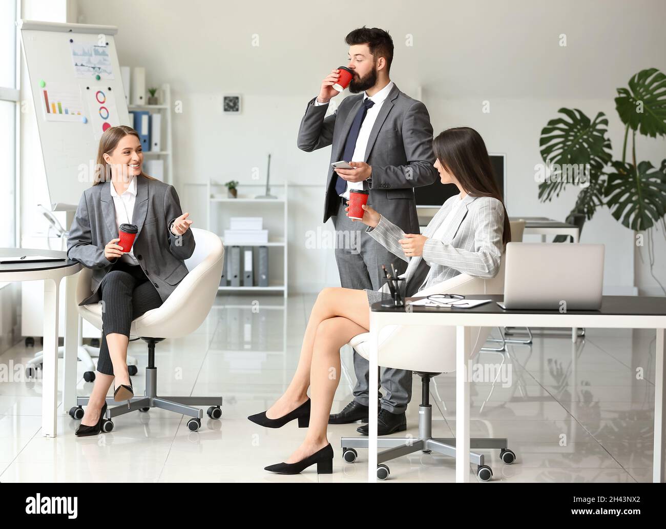 Business people having coffee break in office Stock Photo - Alamy