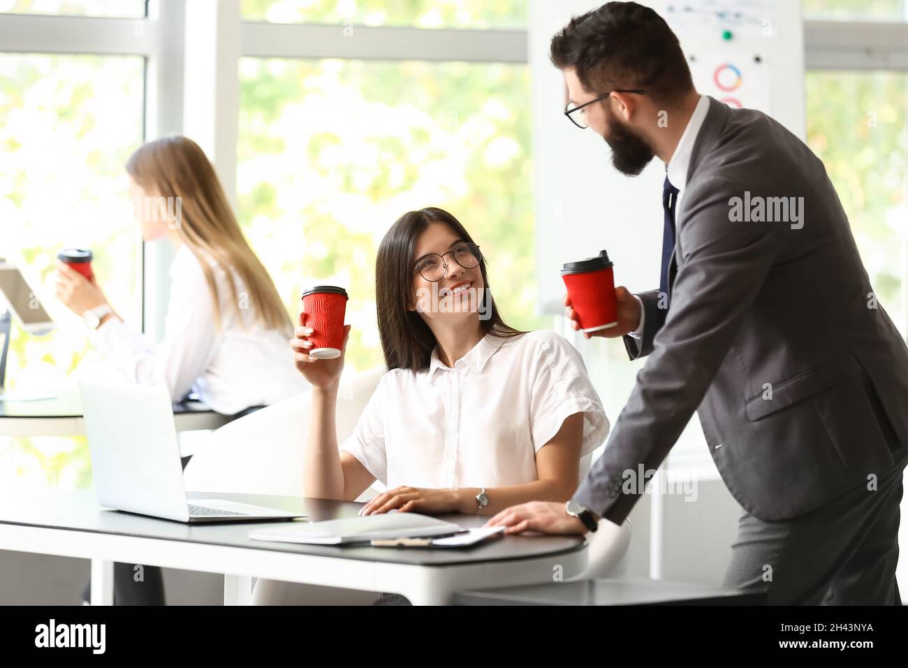 Business people having coffee break in office Stock Photo - Alamy