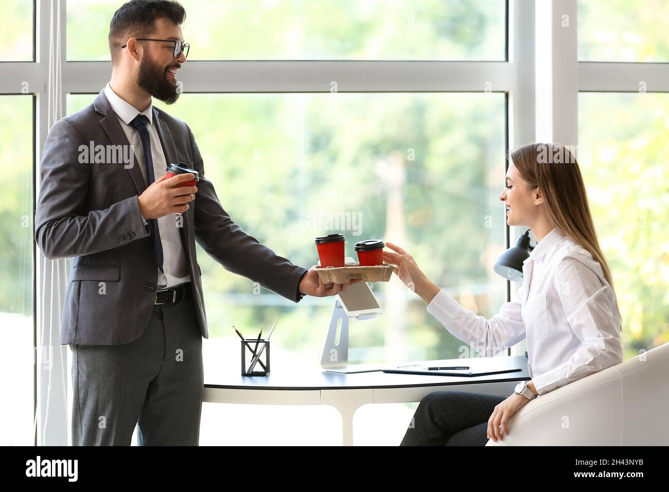 Business people having coffee break in office Stock Photo - Alamy