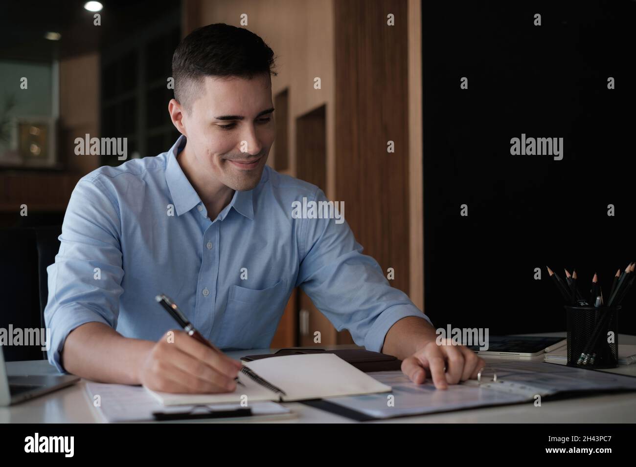 American employee working with stock trading document in home office ...
