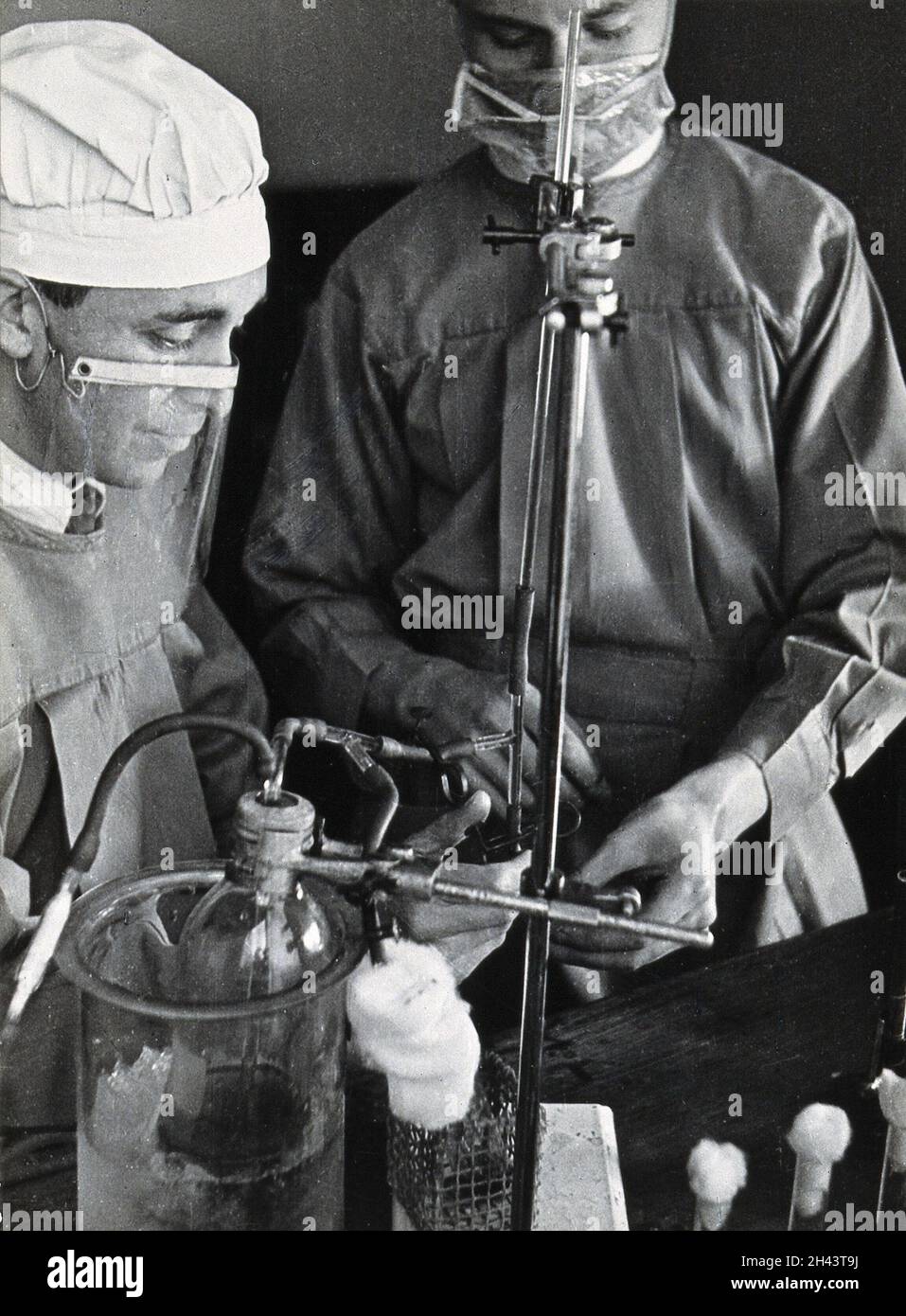 Yellow fever: two scientists wearing face masks at work in a laboratory ...