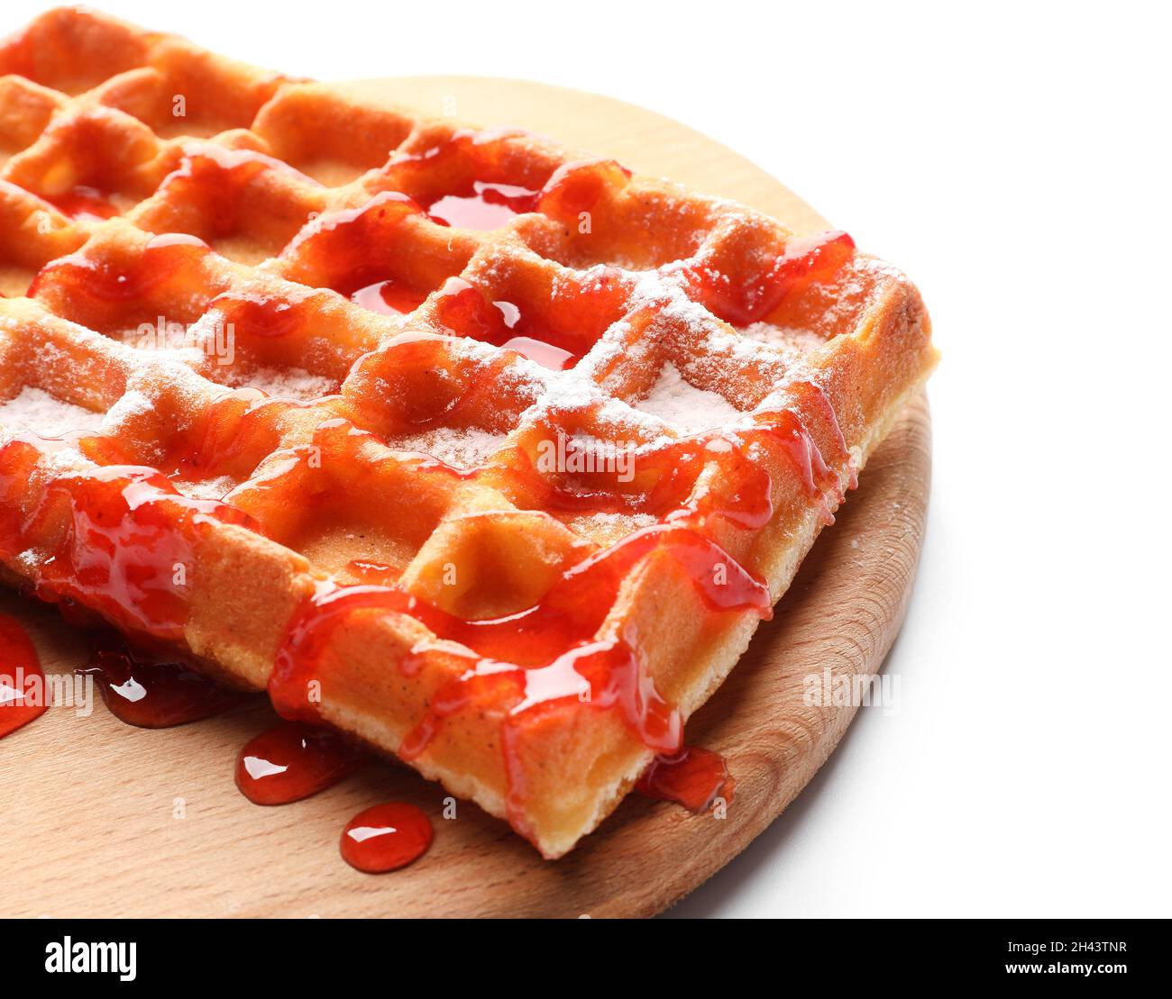 Board with tasty golden Belgian waffle and jam on white background ...