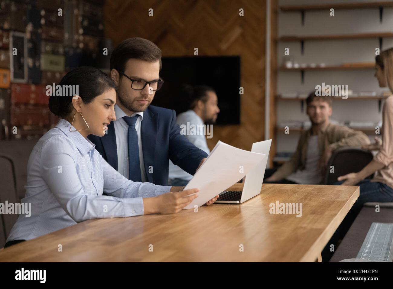 Focused young mixed race employees working in office Stock Photo - Alamy