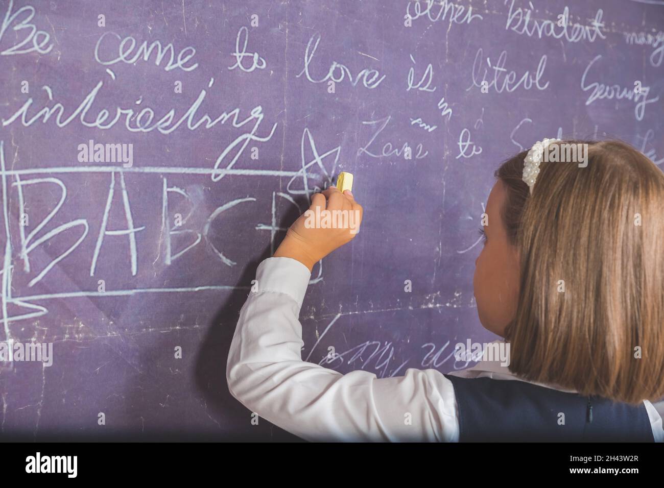 Left Hand writing on a blackboard in white Stock Photo - Alamy