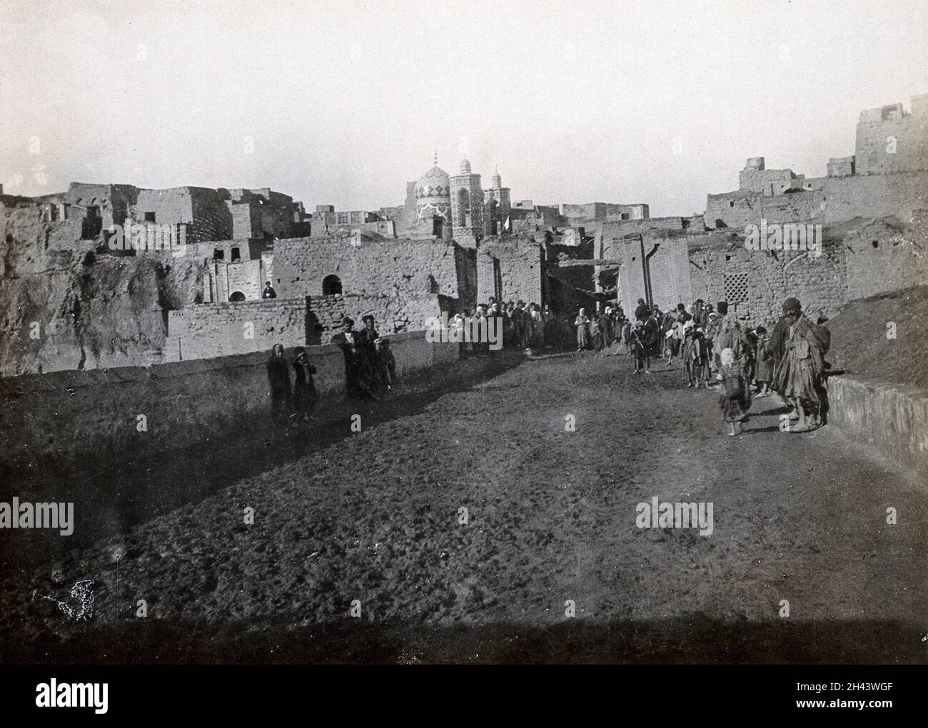 Iran: a roadway leading towards a town with a decorative mosque ...