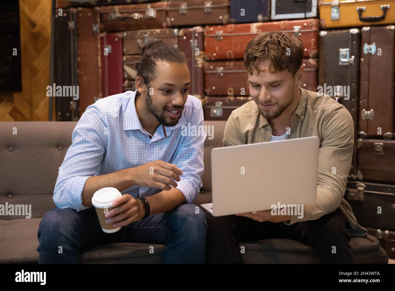Happy friendly young diverse employees using computer Stock Photo - Alamy