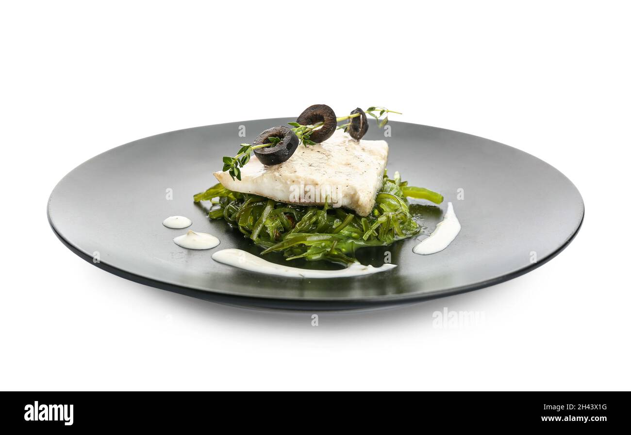 Plate of tasty sea bass fish with seaweed on white background Stock ...