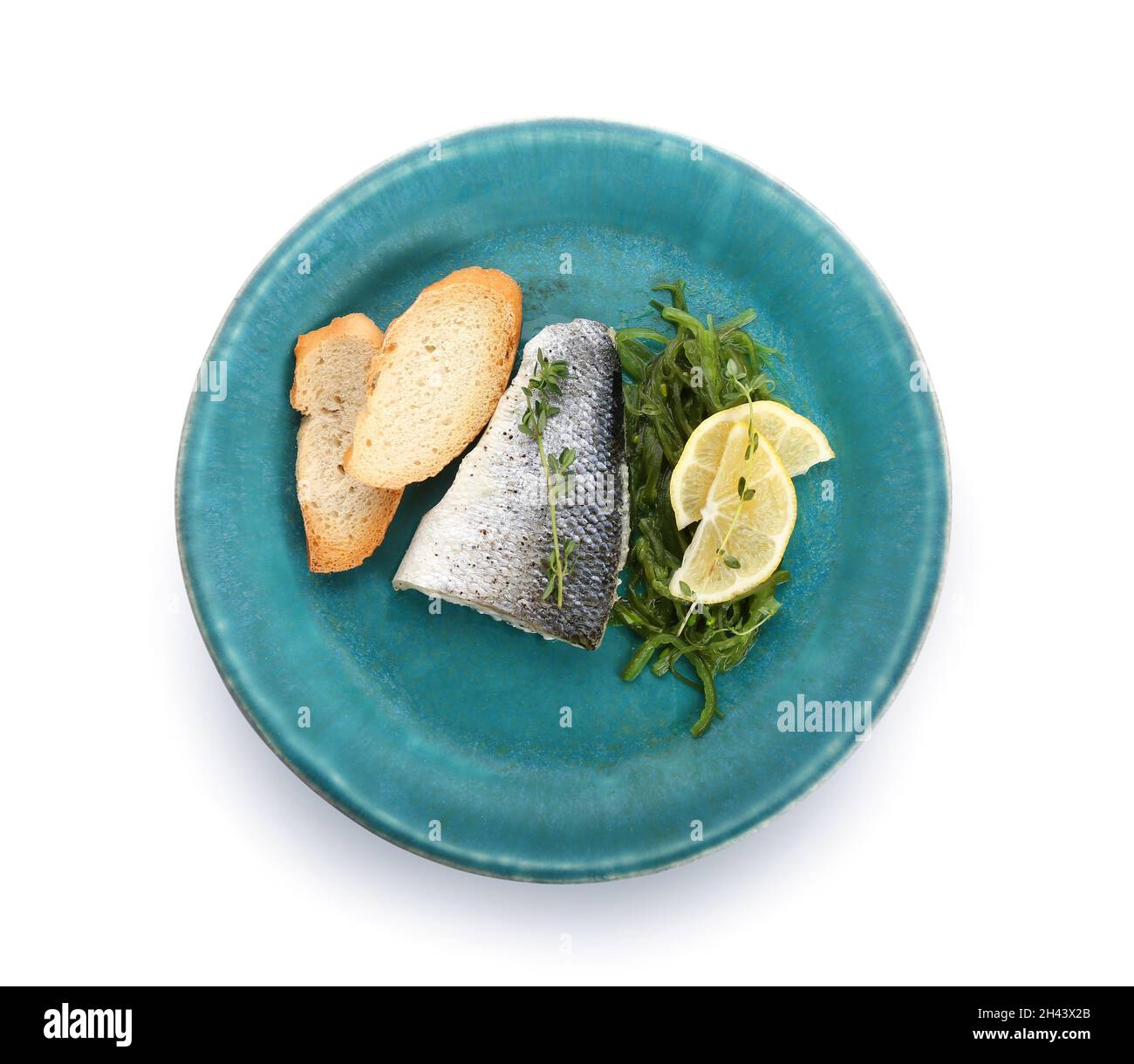 Plate of tasty sea bass fish on white background Stock Photo - Alamy