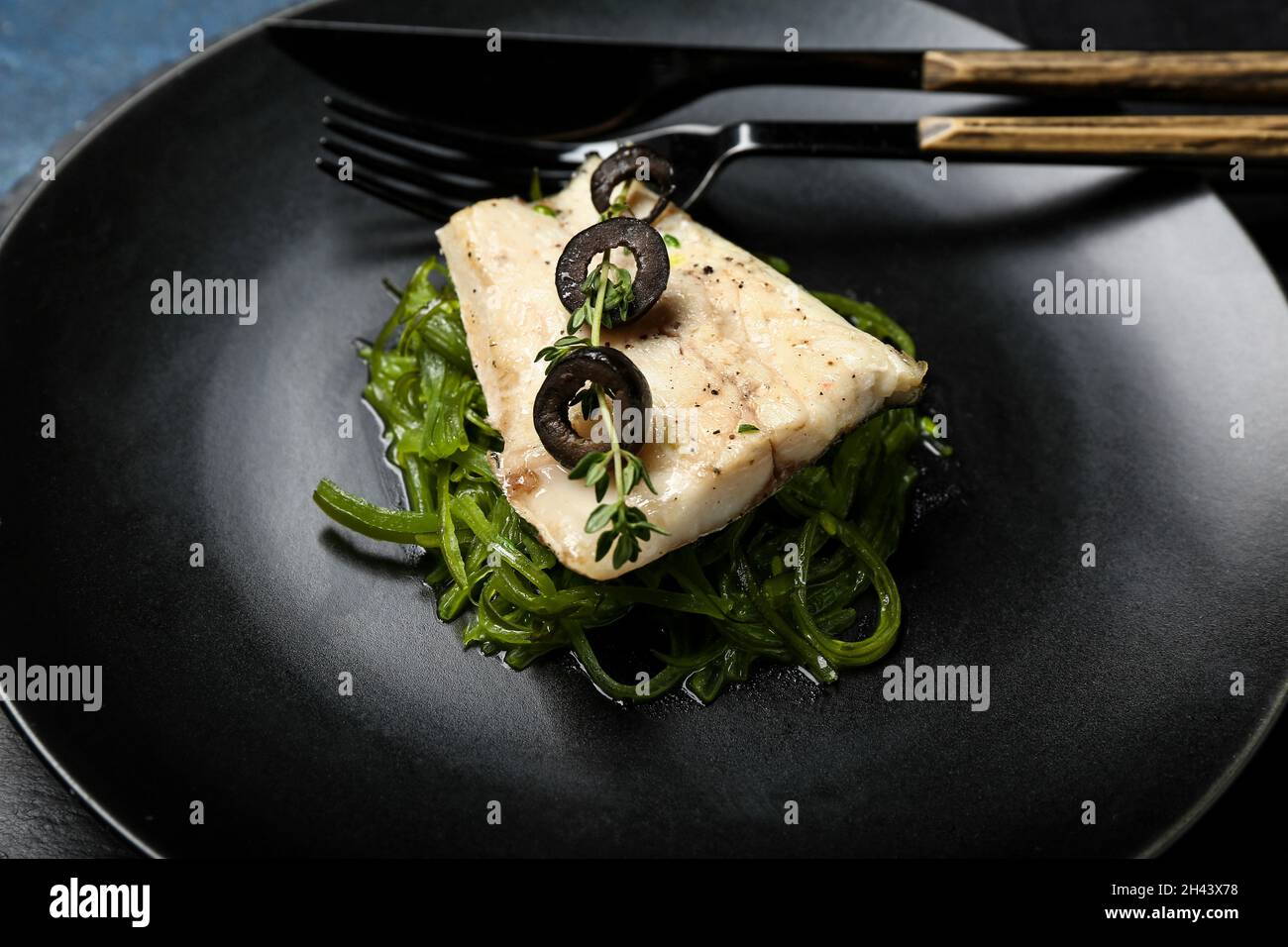 Plate of delicious sea bass fish on table, closeup Stock Photo - Alamy